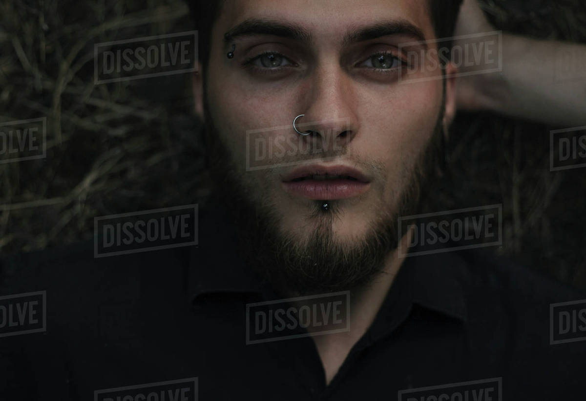 Serious Caucasian man with eyebrow and nose piercing - Stock Photo ...