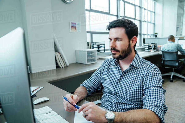 Businessman using computer - Stock Photo - Dissolve