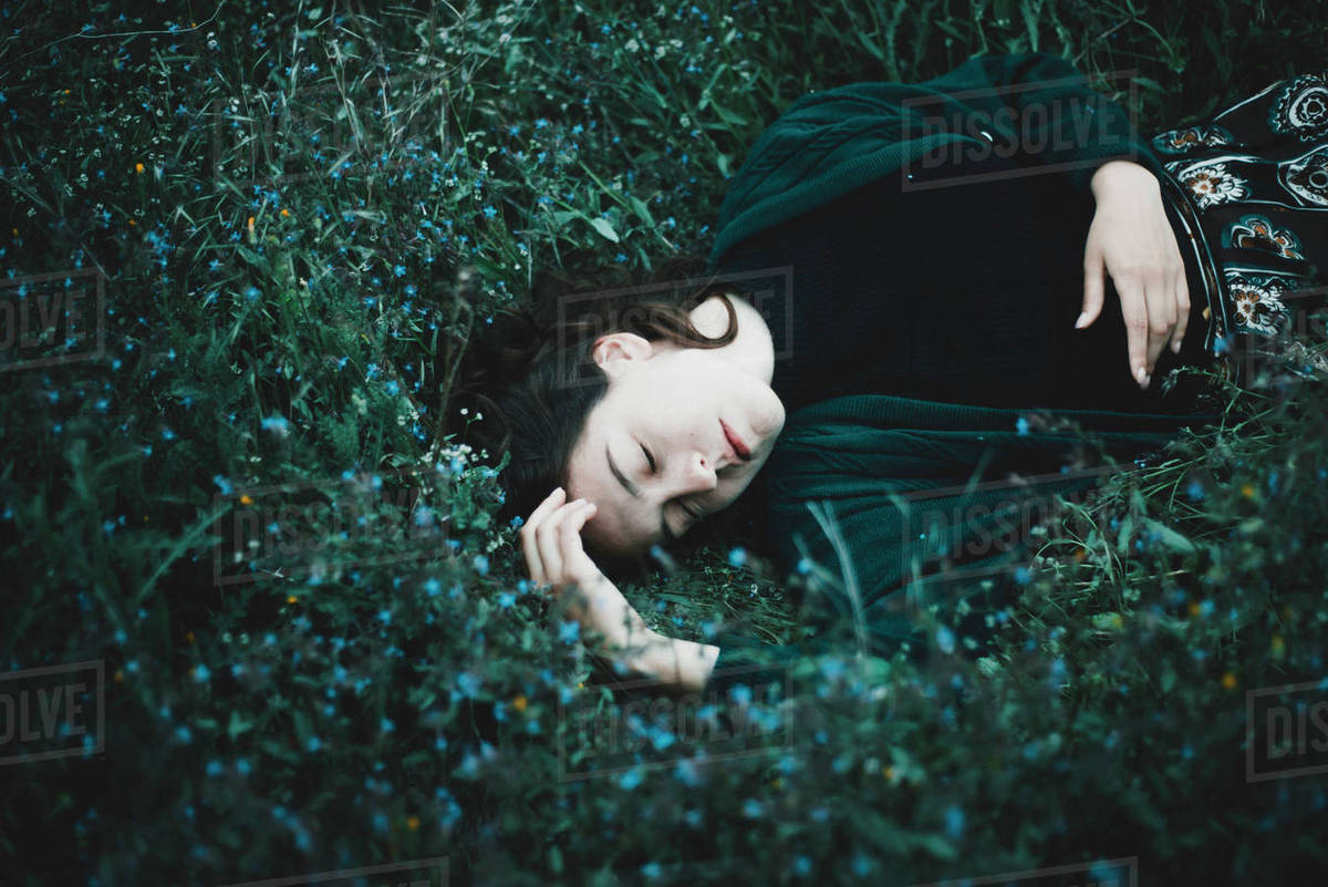 Caucasian woman laying in field of wildflowers - Royalty-free Stock ...