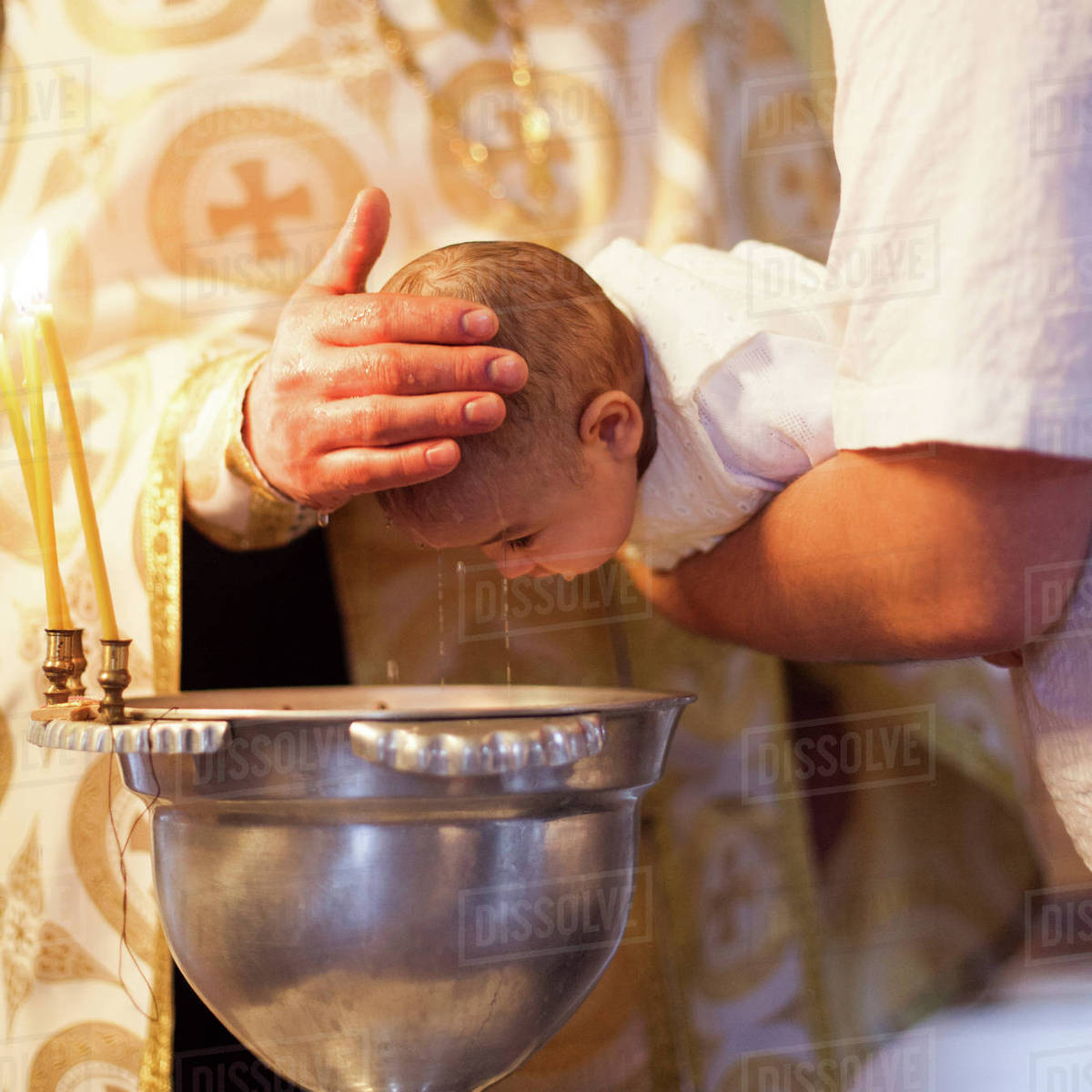 Caucasian baby girl being baptized - Stock Photo - Dissolve