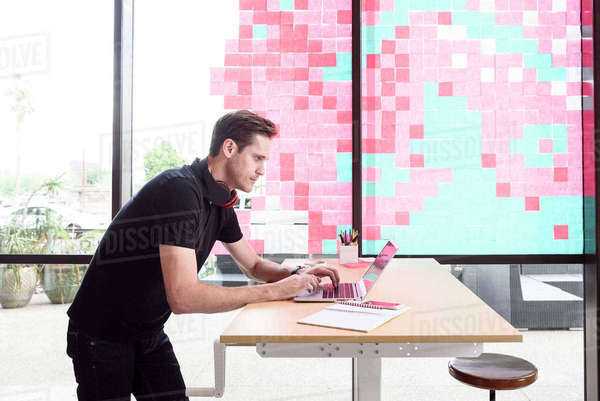 Caucasian man typing on laptop - Stock Photo - Dissolve