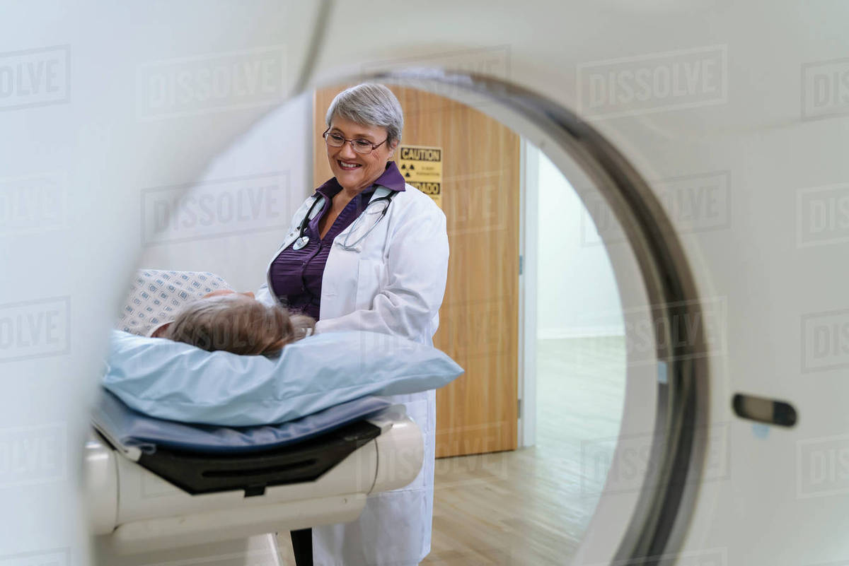 Doctor talking to patient at scanner - Royalty-free Stock Photo | Dissolve