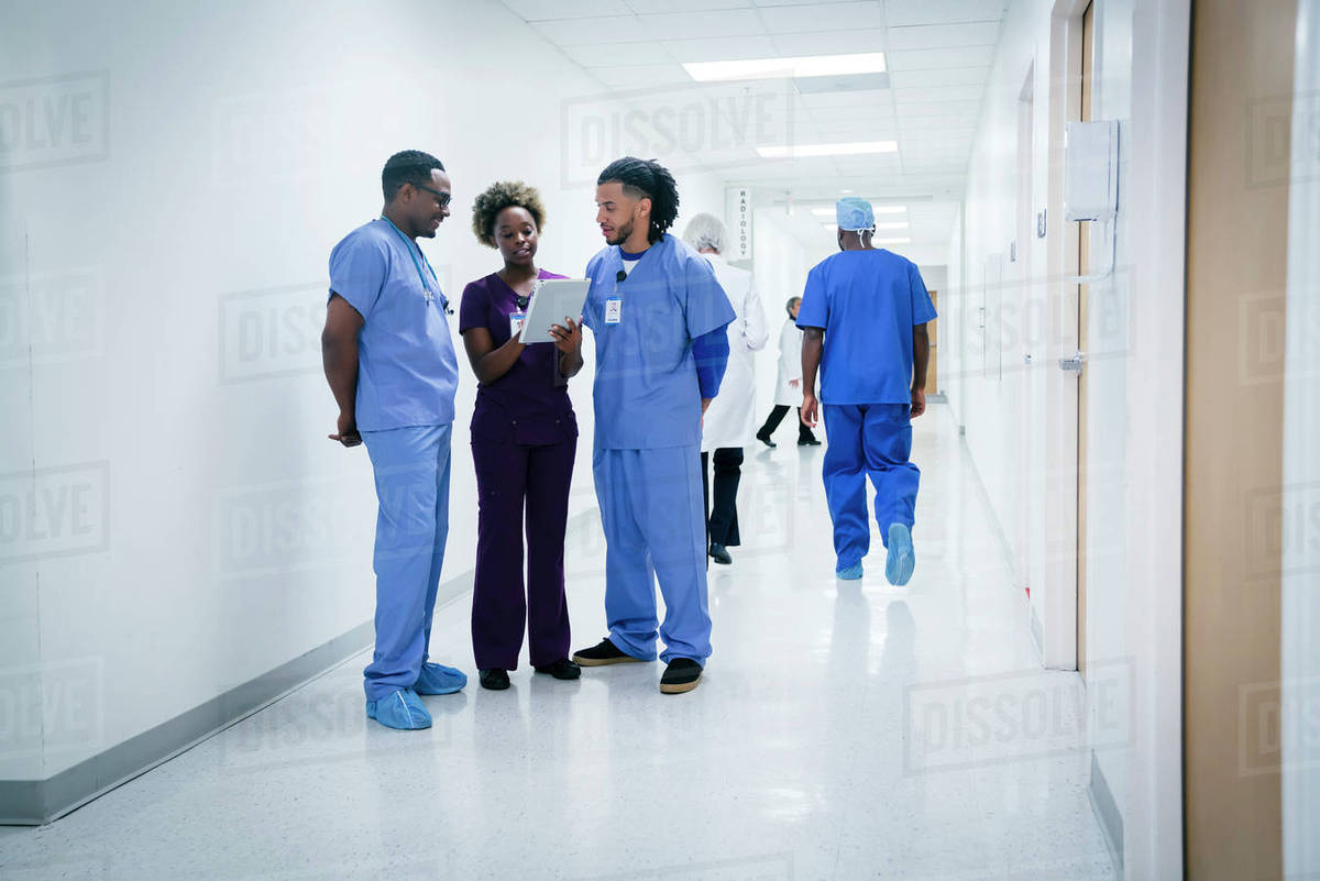 Nurses discussing digital tablet in hospital - Royalty-free Stock Photo ...