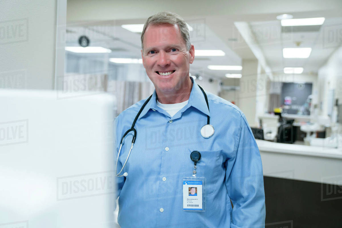 Portrait of smiling doctor using computer in hospital - Royalty-free ...