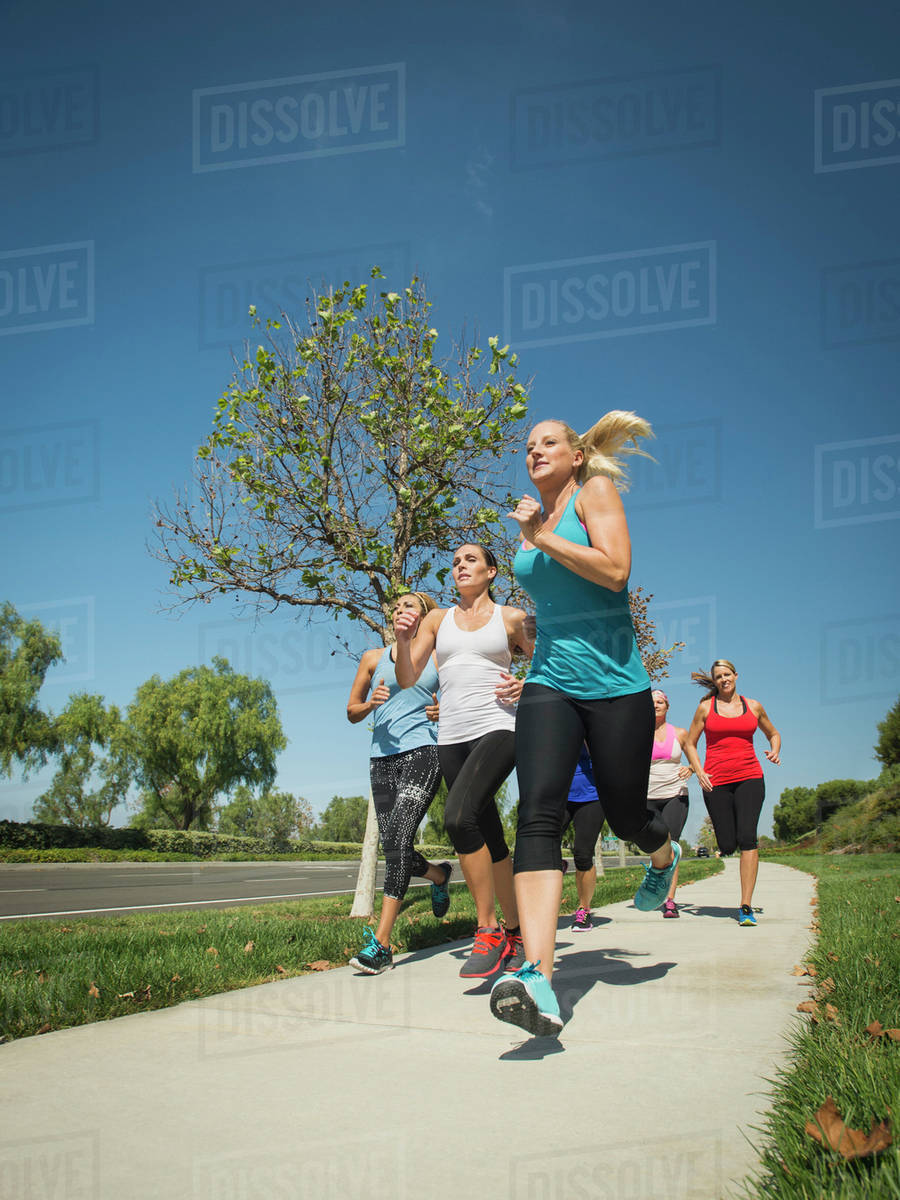 People jogging together outdoors - Stock Photo - Dissolve