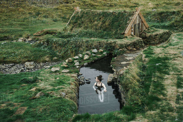 Caucasian woman swimming in pond near rural house - Royalty-free Stock ...