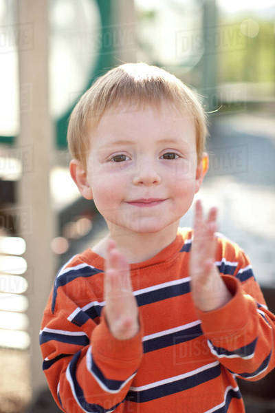 Caucasian boy clapping his hands - Royalty-free Stock Photo | Dissolve