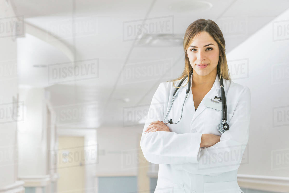 Mixed race doctor smiling in hospital - Royalty-free Stock Photo | Dissolve