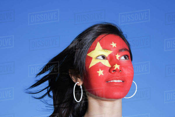 Chinese girl with Chinese flag painted on face - Stock Photo - Dissolve