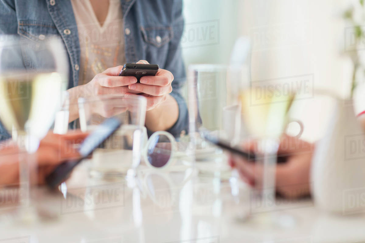 People using cell phones at dinner table - Royalty-free Stock Photo ...