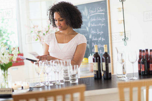 Mixed race hostess working in restaurant - Royalty-free Stock Photo ...
