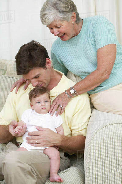 Three generations of family on sofa - Royalty-free Stock Photo | Dissolve