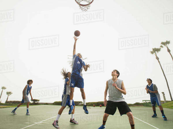 Basketball teams playing on court - Royalty-free Stock Photo | Dissolve