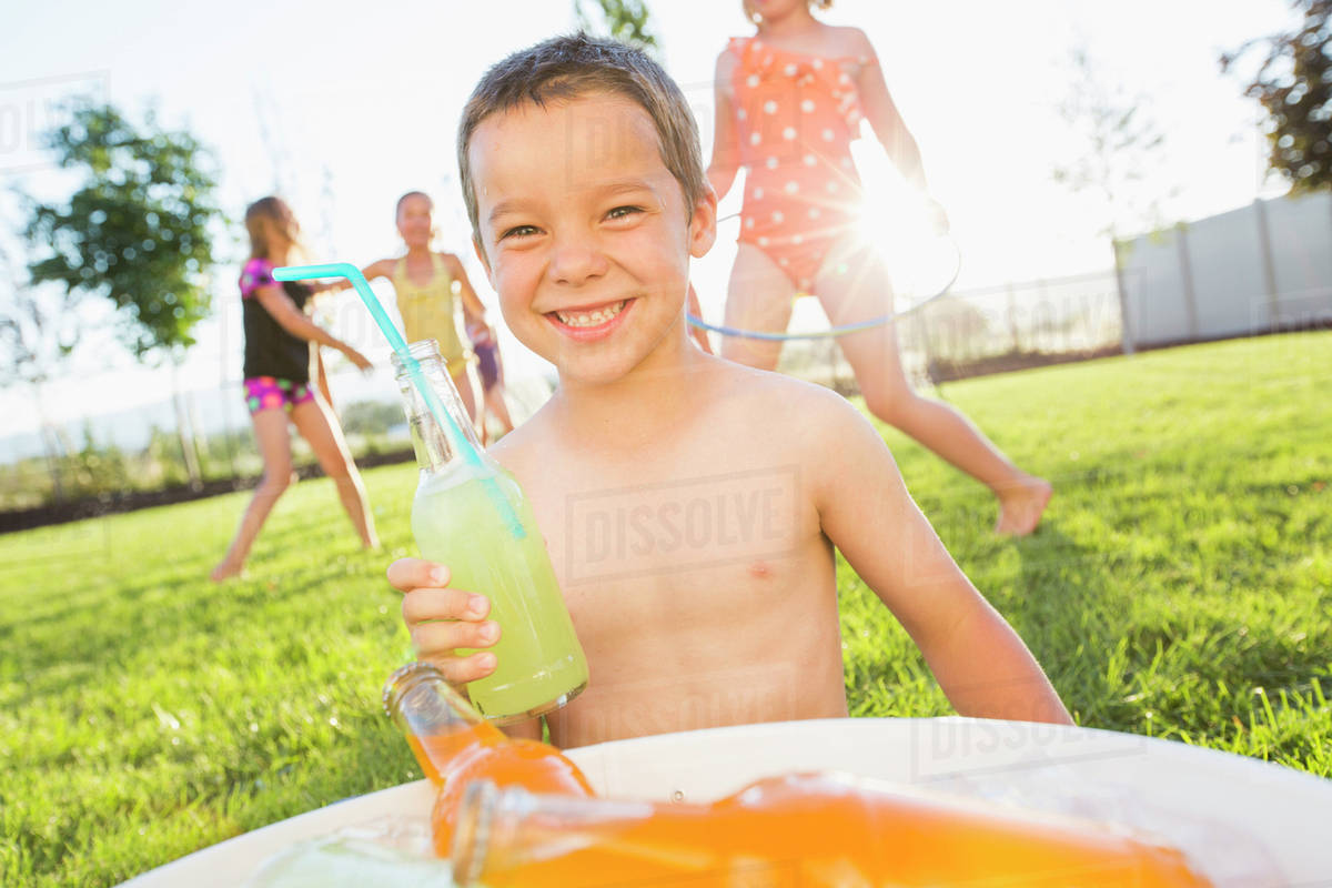 Caucasian boy drinking soda in backyard - Royalty-free Stock Photo ...