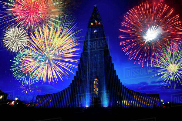 Fireworks exploding over monument in night sky, Reykjavik ...