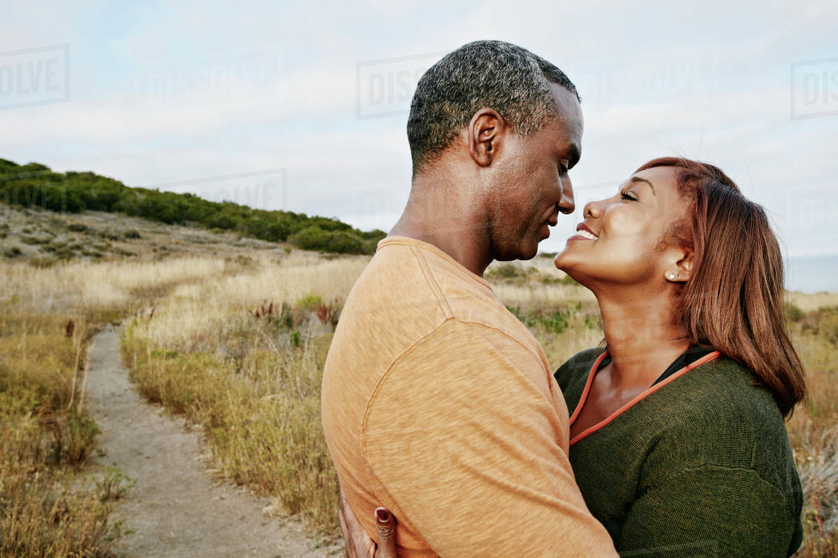 Black couple hugging on rural path - Royalty-free Stock Photo | Dissolve