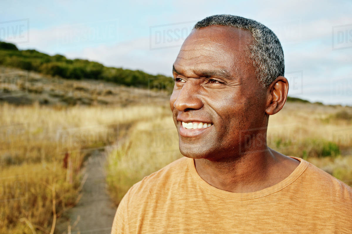 Black man standing on rural path - Royalty-free Stock Photo | Dissolve