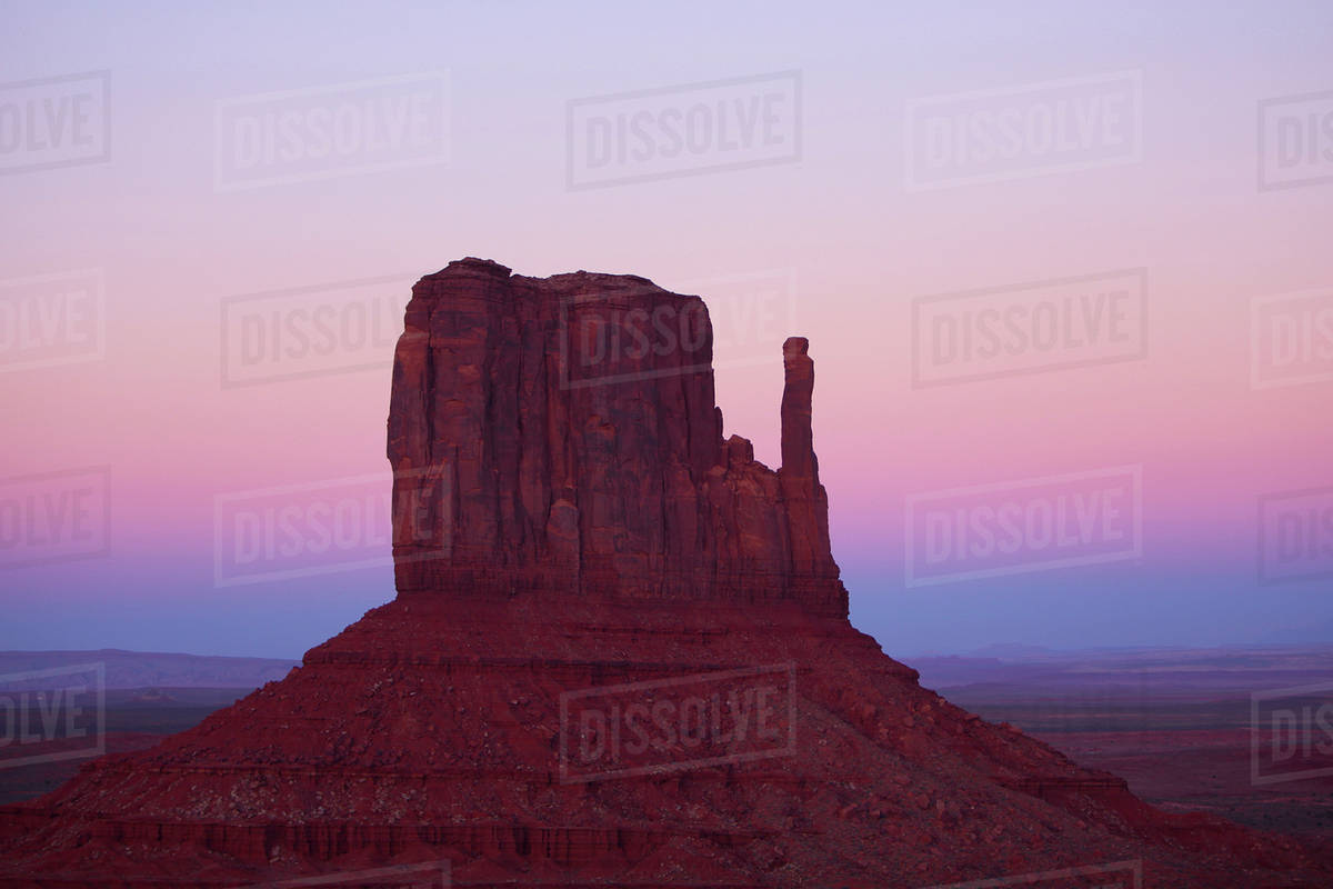 Butte rock formation in desert landscape, Monument Valley Tribal Park ...