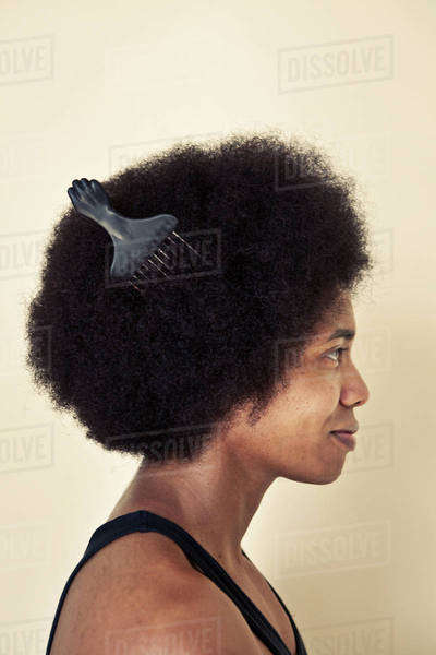 African American man wearing comb in afro hairstyle - Stock Photo ...