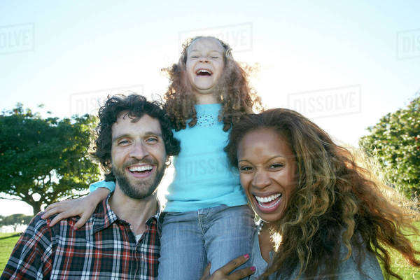 Family laughing together outdoors - Stock Photo - Dissolve