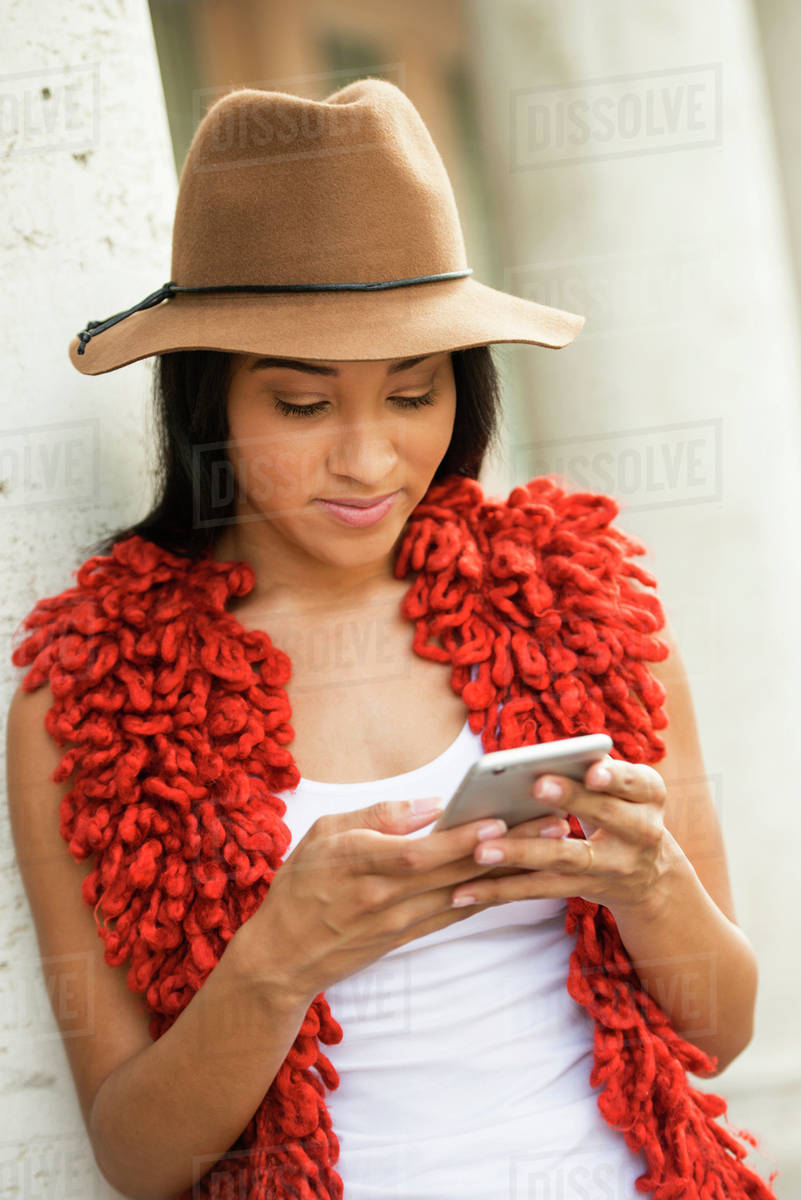 Black woman using cell phone outdoors - Stock Photo - Dissolve