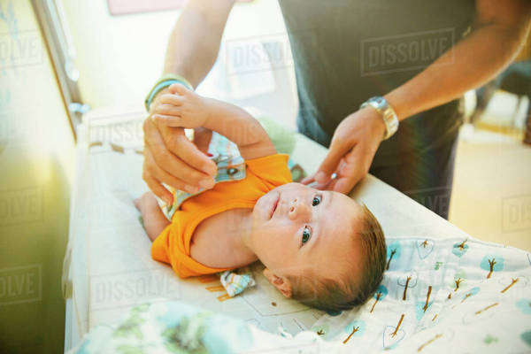 Caucasian father changing diaper of baby boy - Royalty-free Stock Photo ...