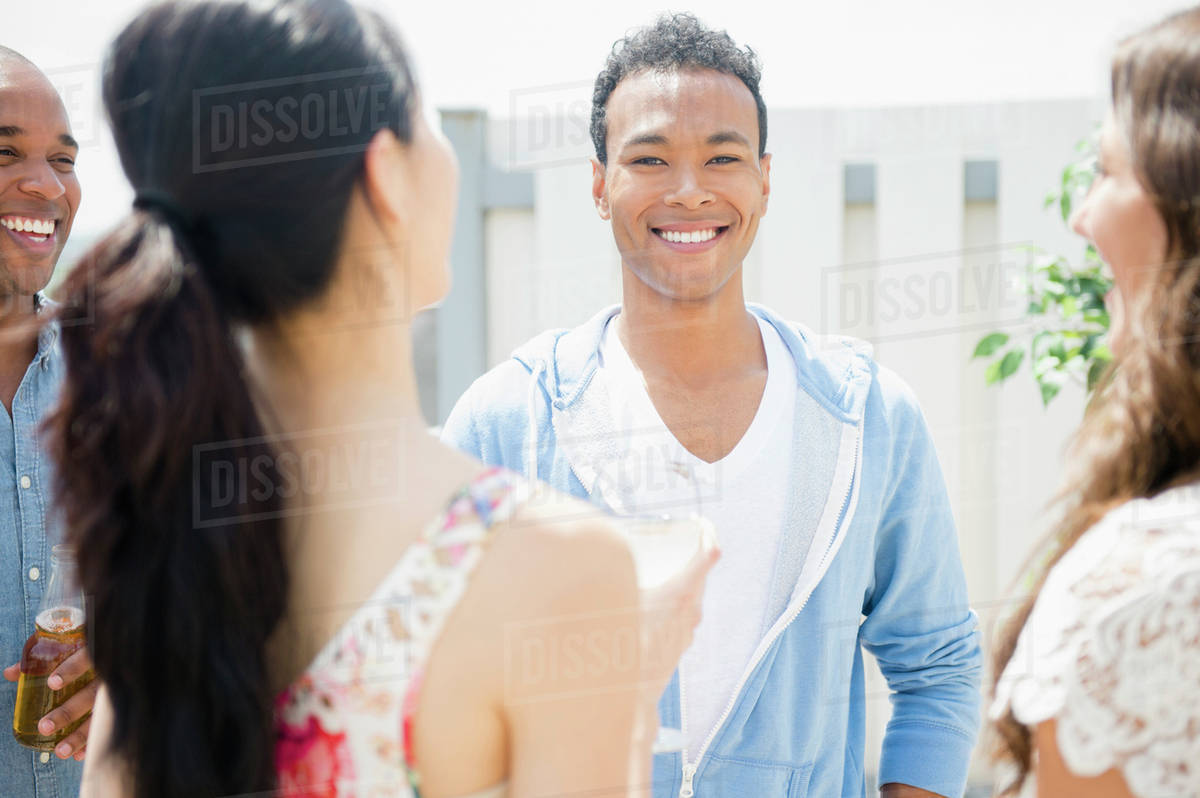 Friends talking at party - Royalty-free Stock Photo | Dissolve