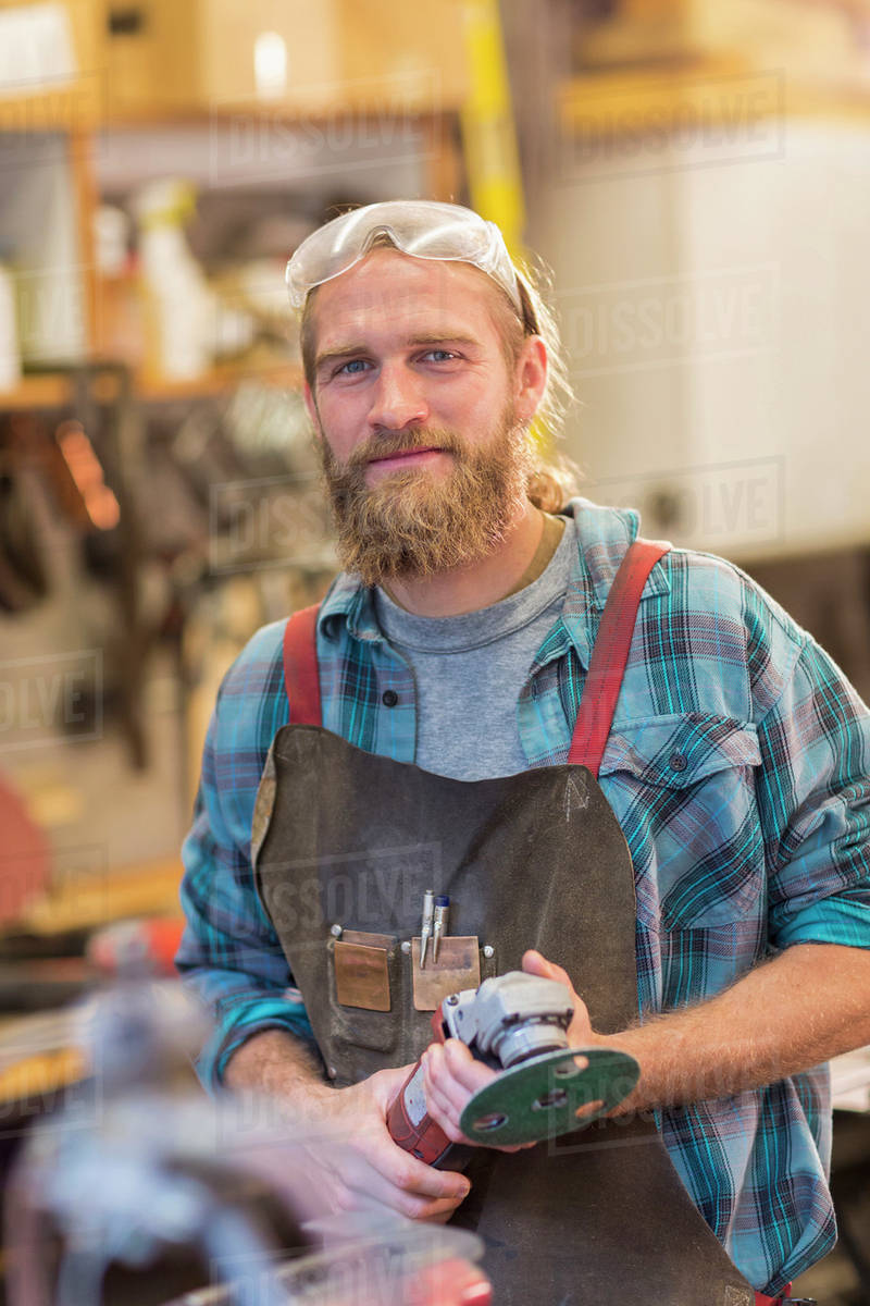 Caucasian craftsman smiling in workshop - Royalty-free Stock Photo ...