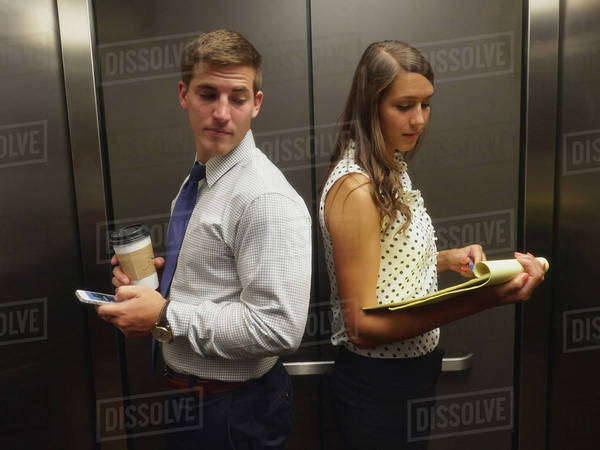 Business people ignoring each other in elevator - Royalty-free Stock ...