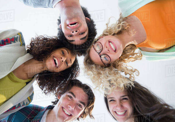Friends huddled in circle together - Royalty-free Stock Photo | Dissolve