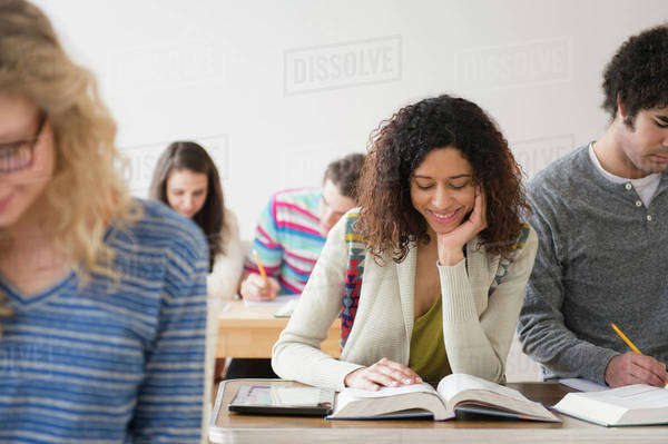 Students working in class - Stock Photo - Dissolve