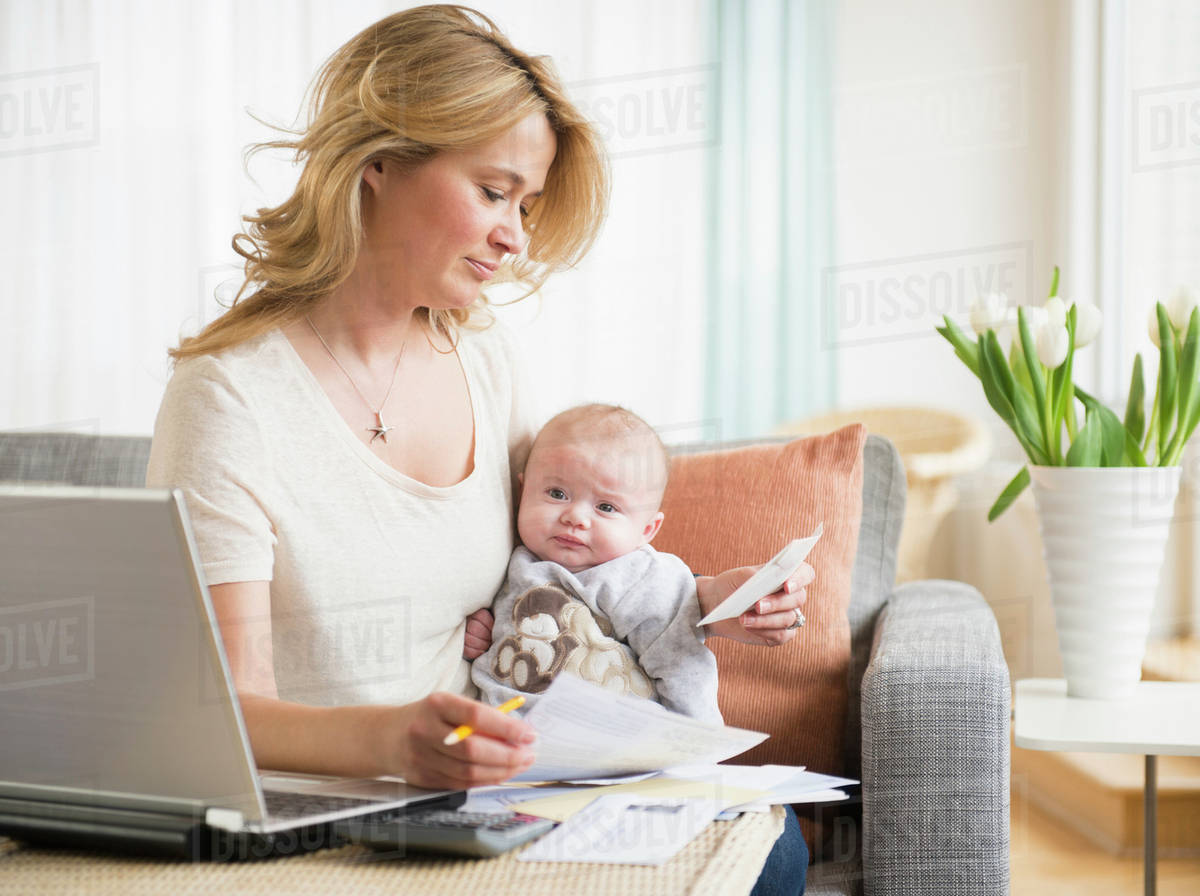 Caucasian mother with baby paying bills - Royalty-free Stock Photo ...