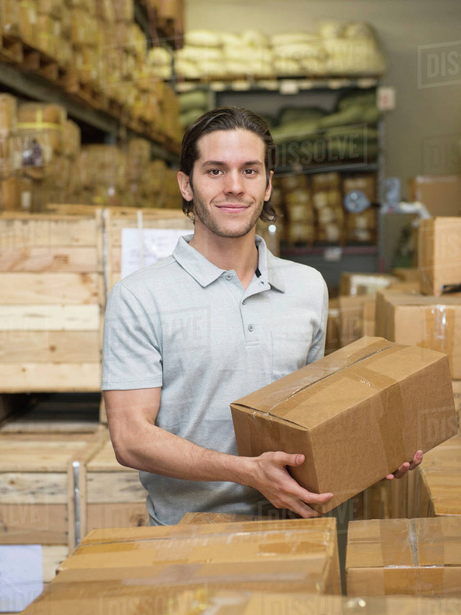 Mixed race worker stacking boxes in textile factory - Stock Photo ...