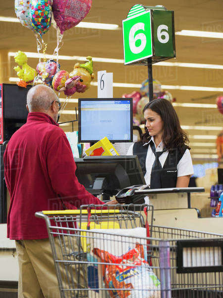 Cashier and customer at grocery store checkout - Royalty-free Stock ...