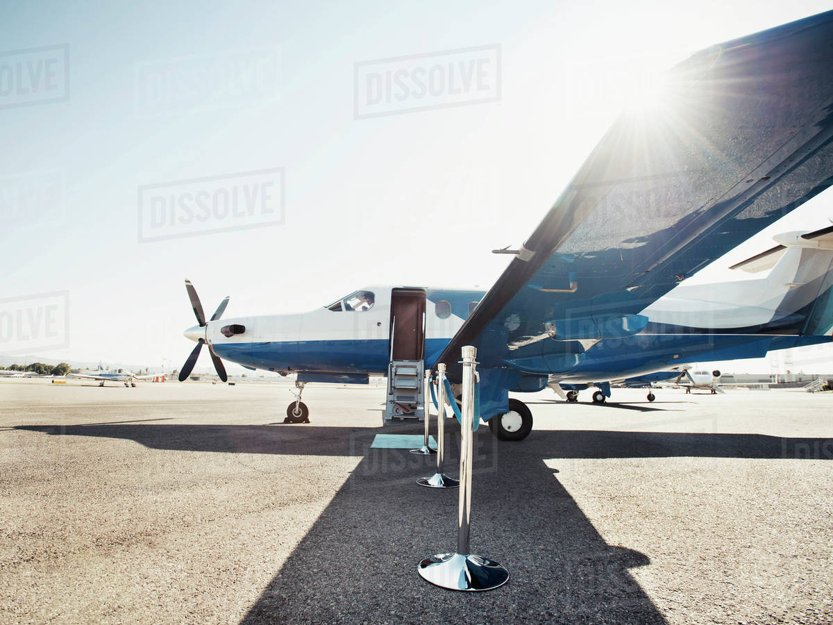 Velvet rope by airplane on runway - Royalty-free Stock Photo | Dissolve