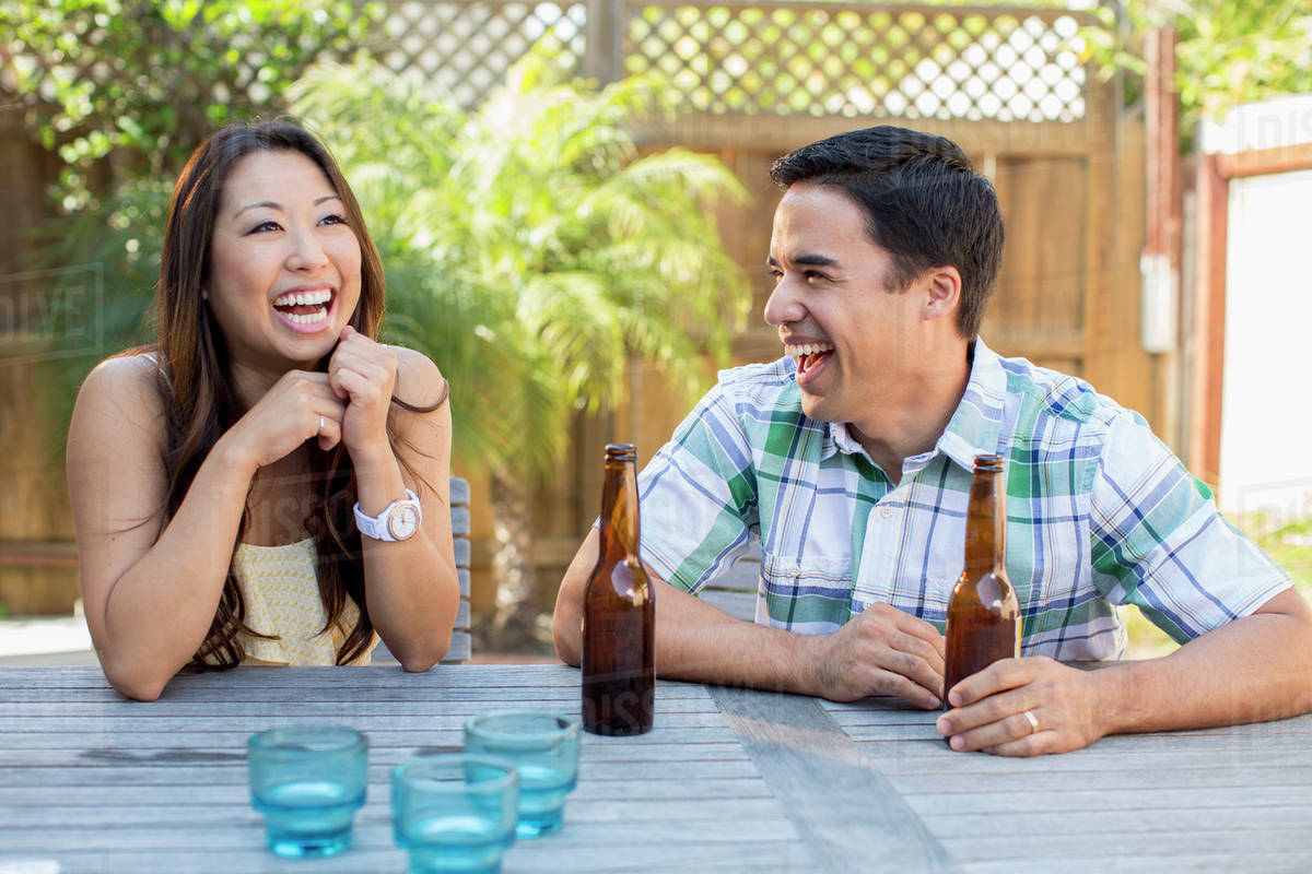 Couple having beers in backyard - Royalty-free Stock Photo | Dissolve