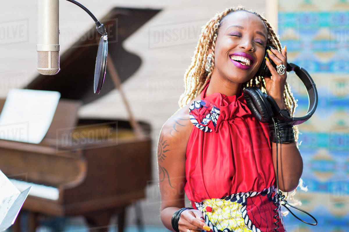 African American singer listening to track in studio - Royalty-free ...
