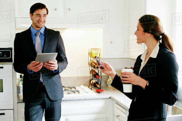 Couple talking in kitchen - Stock Photo - Dissolve