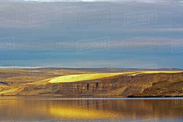 Barren Cliff Face Reflected in Water - Royalty-free Stock Photo | Dissolve