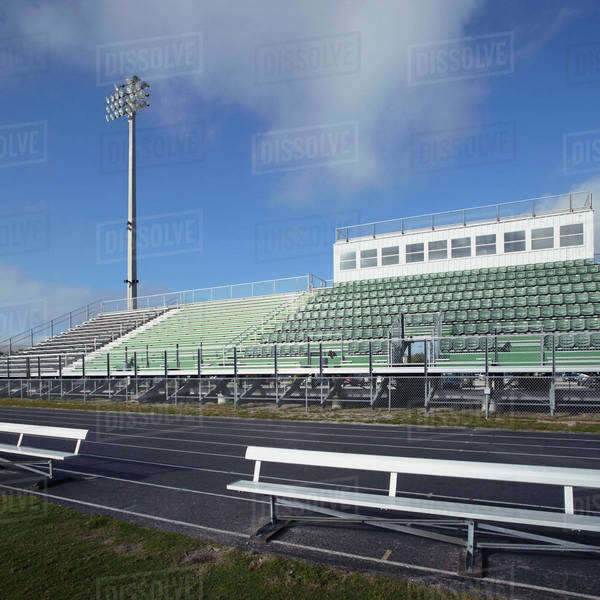 Empty running track and bleachers - Stock Photo - Dissolve