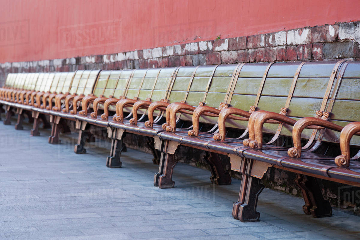 Benches run along a wall inside the Forbidden City in Beijing, China ...