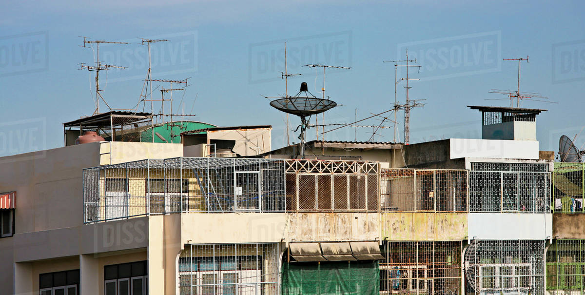 Apartment building with satellite dish - Stock Photo - Dissolve