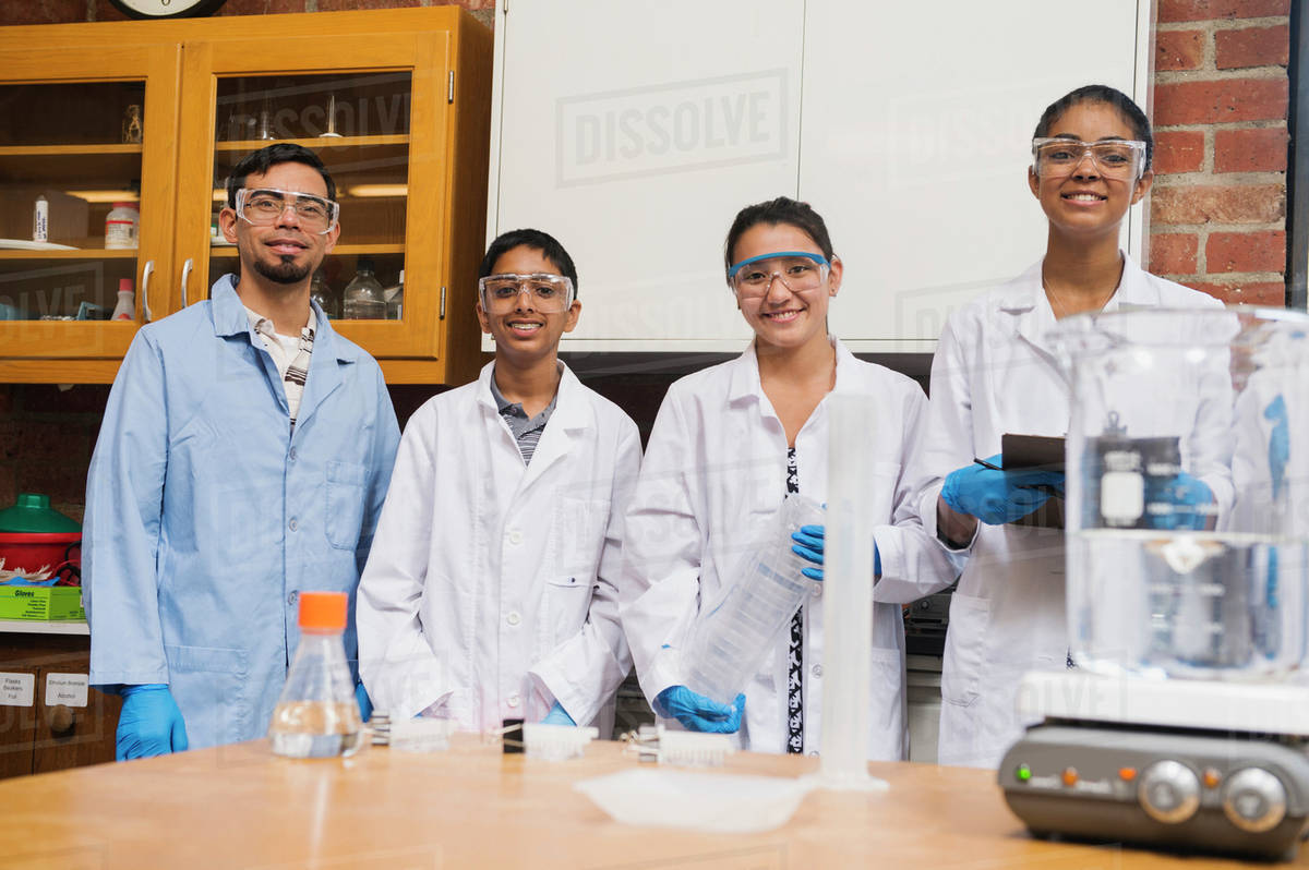 Teacher and students smiling in science lab - Royalty-free Stock Photo ...