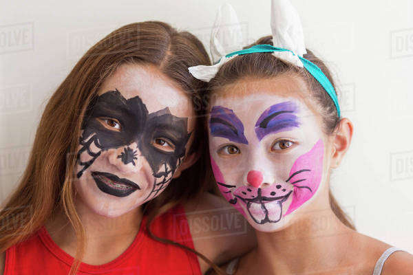 Mixed race girls wearing face paint - Royalty-free Stock Photo | Dissolve