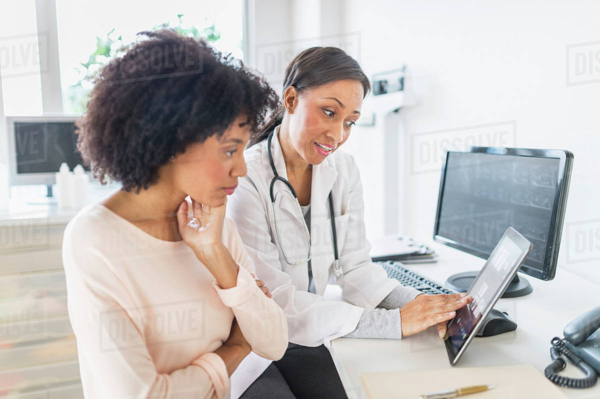 African American doctor and patient talking in office - Stock Photo ...