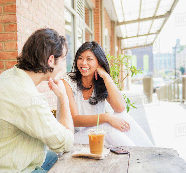 Couple enjoying iced coffee at sidewalk cafe - Royalty-free Stock Photo ...