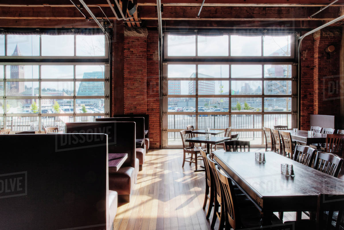 Tables and chairs in empty restaurant - Royalty-free Stock Photo | Dissolve