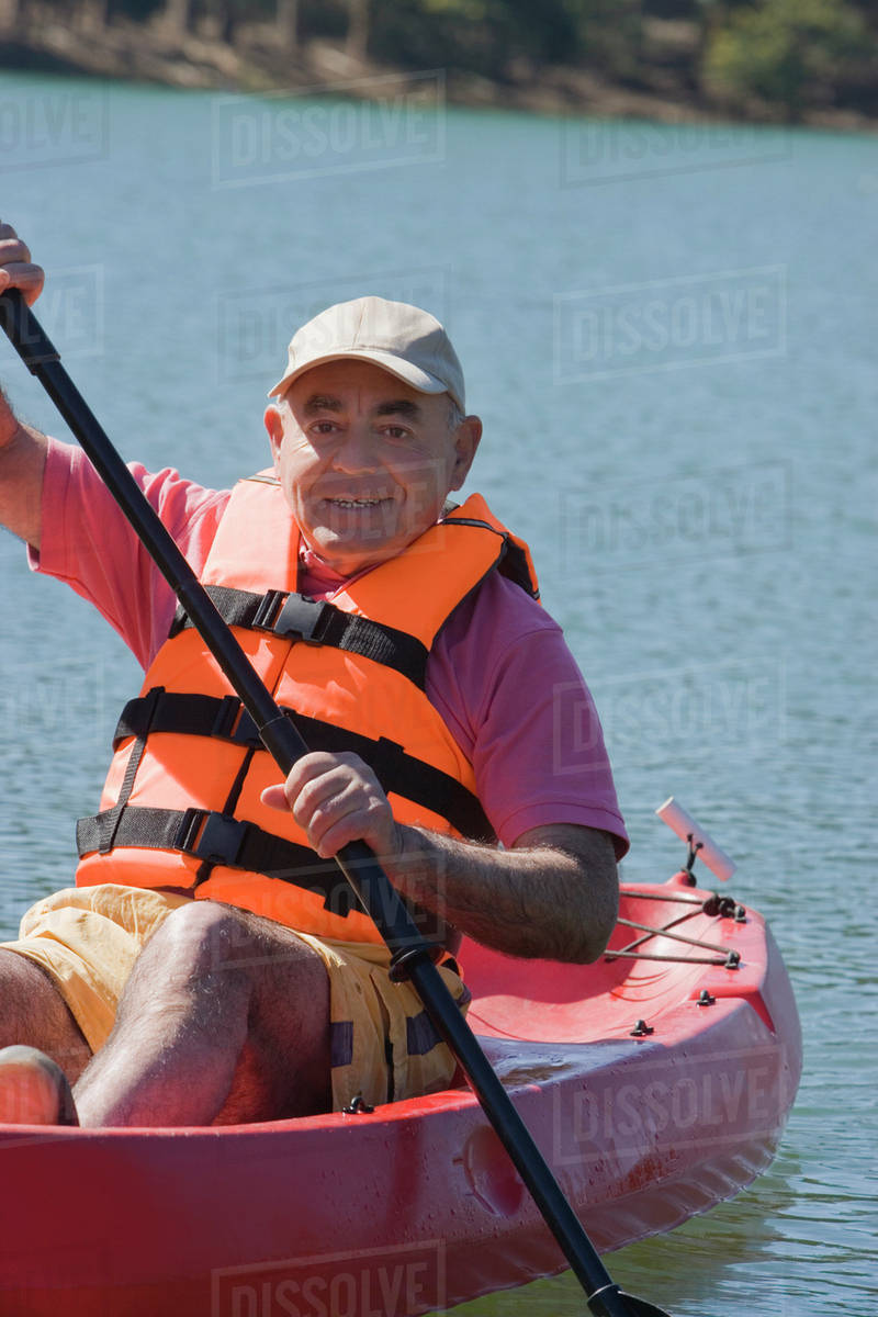Chilean man paddling kayak - Stock Photo - Dissolve