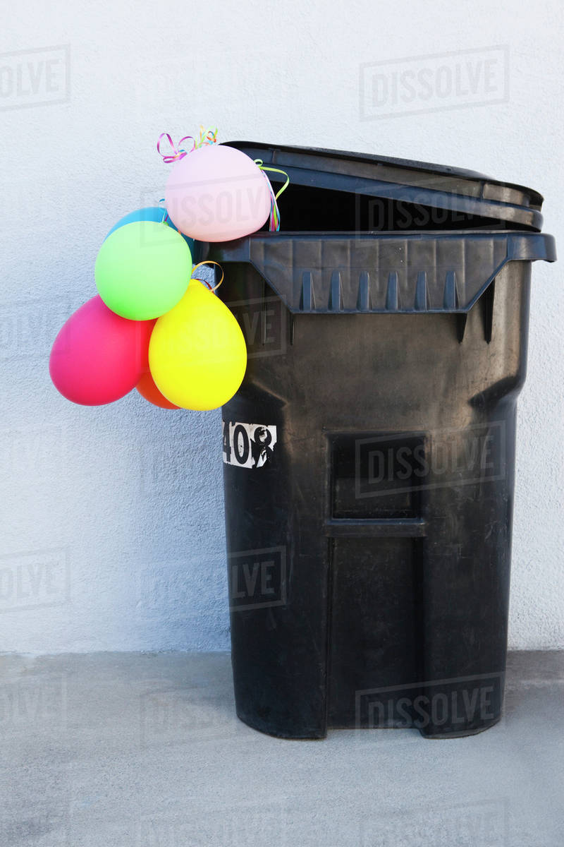 Bunch of balloons in garbage can - Royalty-free Stock Photo | Dissolve