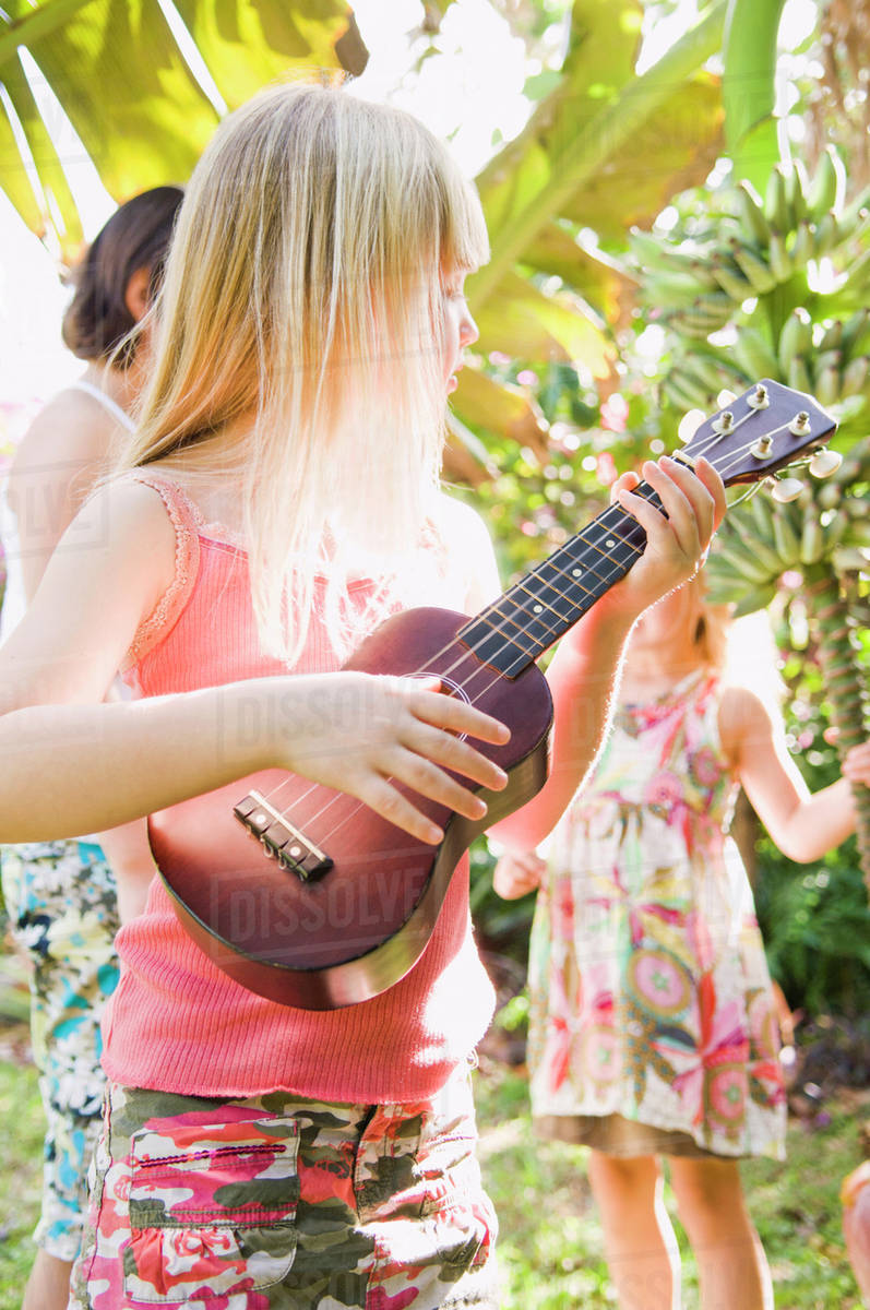 Caucasian girl playing ukulele outdoors - Royalty-free Stock Photo ...